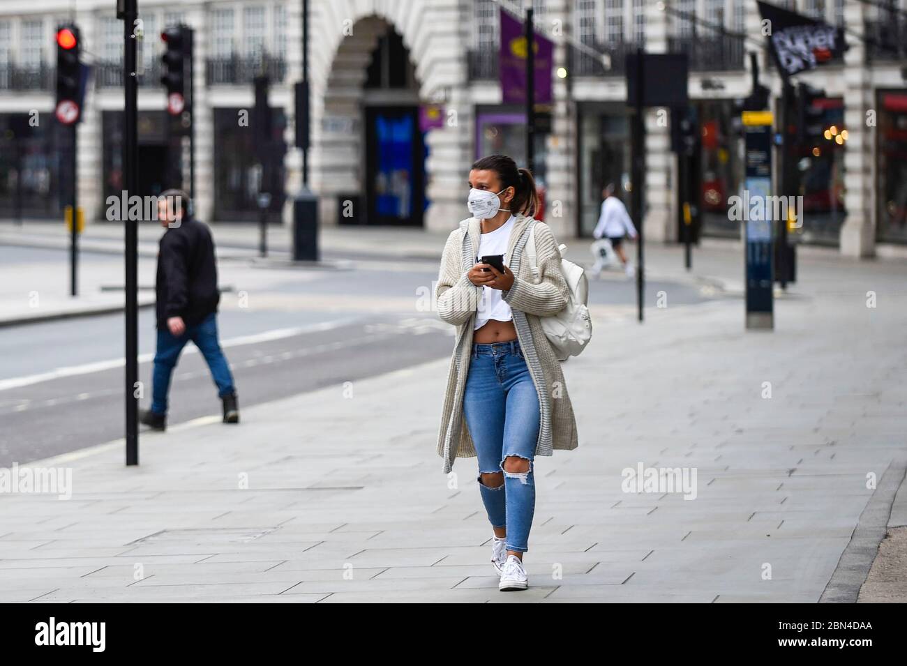 London, UK. 12 May 2020. A woman wears a facemask in central London ...