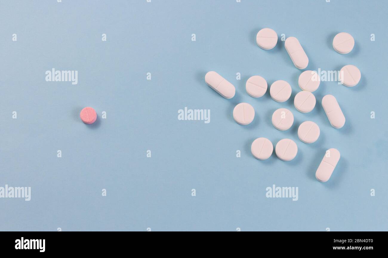 White pills on a blue background are located in a group and one red ...