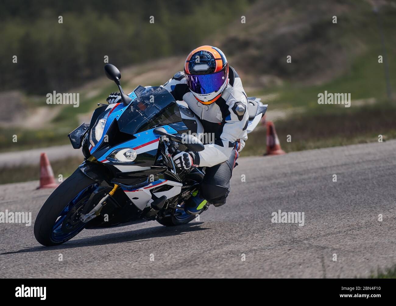 Motorcycle practice leaning into a fast corner on track Stock Photo - Alamy