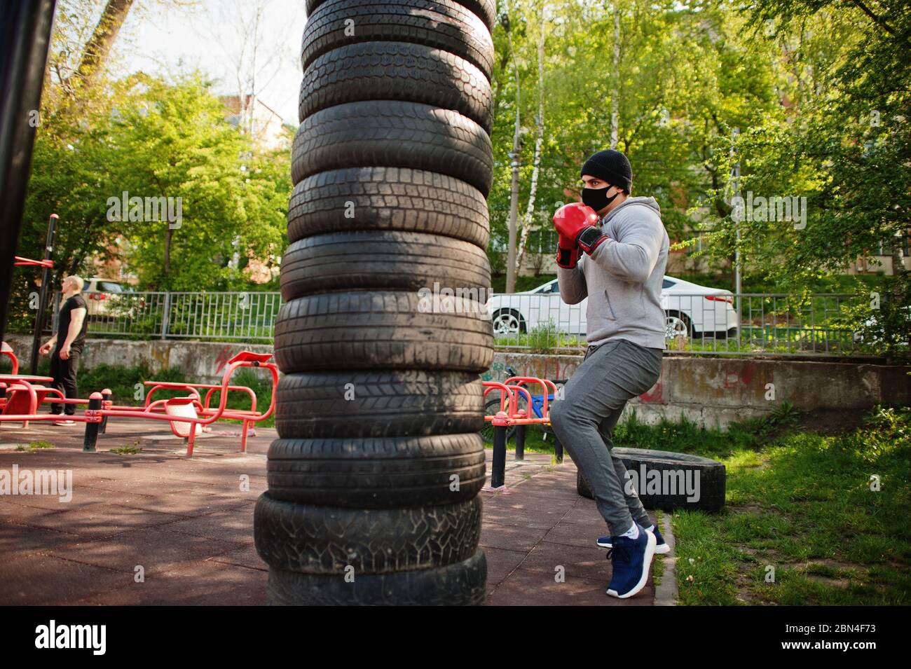 Portrait sports arabian boxer man in black medical face mask boxing ...