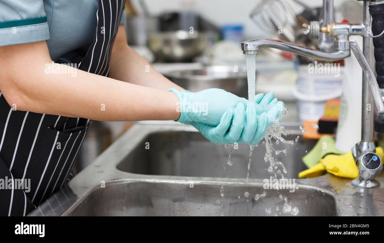 Woman in gloves washing hands hi-res stock photography and images - Alamy