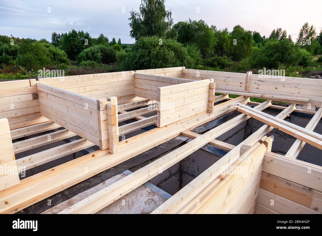 Construction of a new wooden house on the stone foundation Stock Photo ...