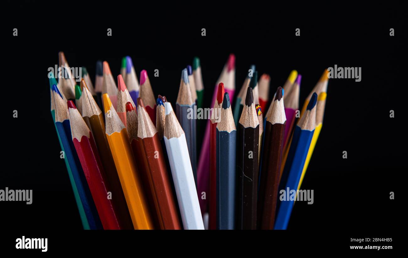 colored pencils on a black background with copy space Stock Photo - Alamy