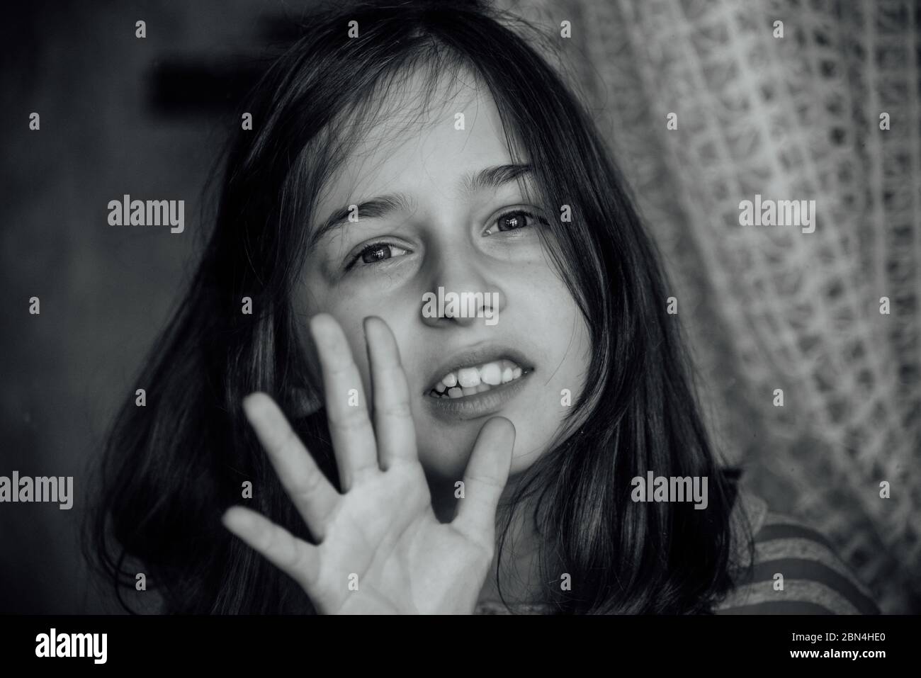 Portrait of a 9 years old female child with black background dark ...