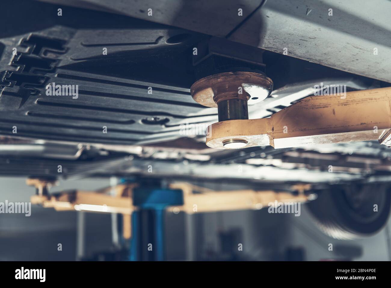 Close Up View Of Under Car Serviced In Garage Being Raised On Hydraulic ...
