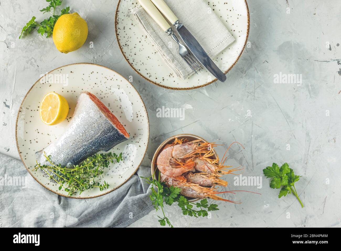 Trout fish surrounded parsley, lemon, shrimp, prawn in ceramic plate ...