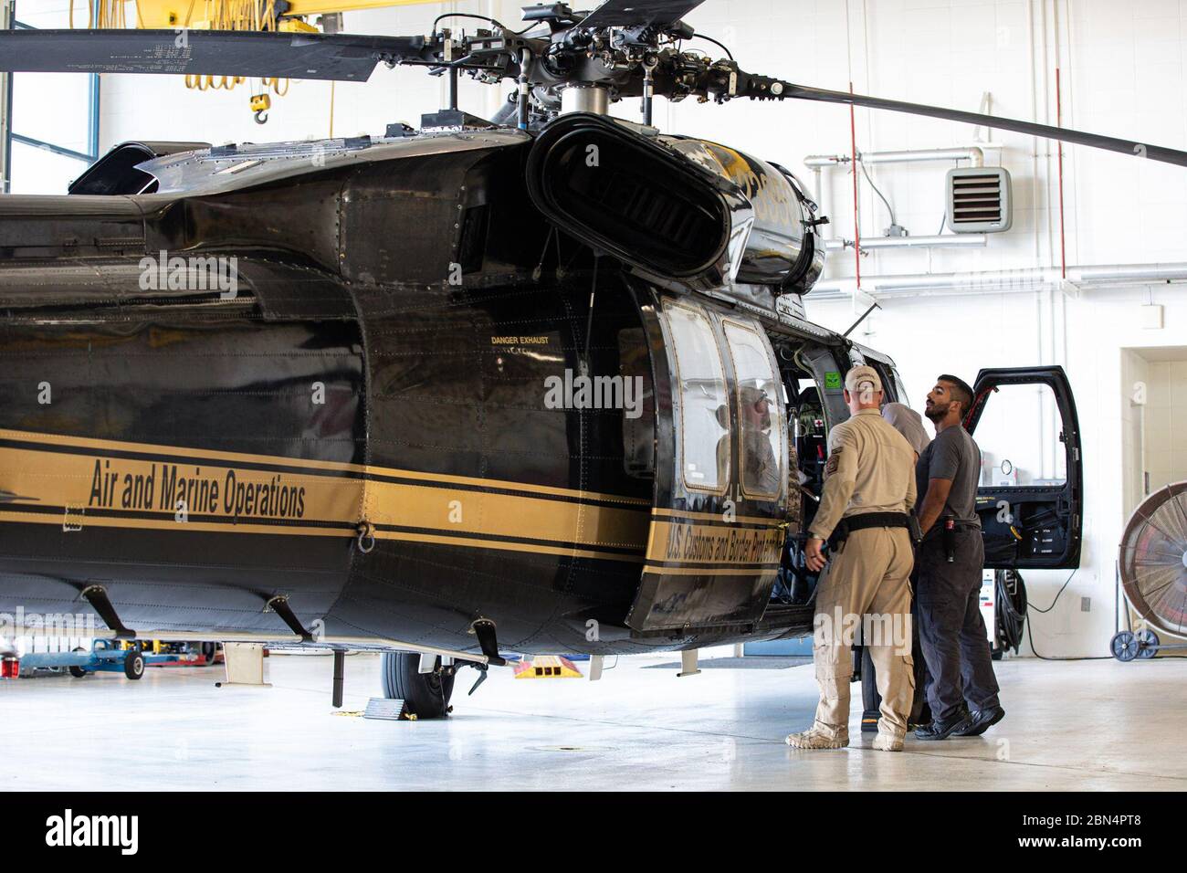A maintenance crew inspects a CBP Air and Marine Operations UH-60 Black ...