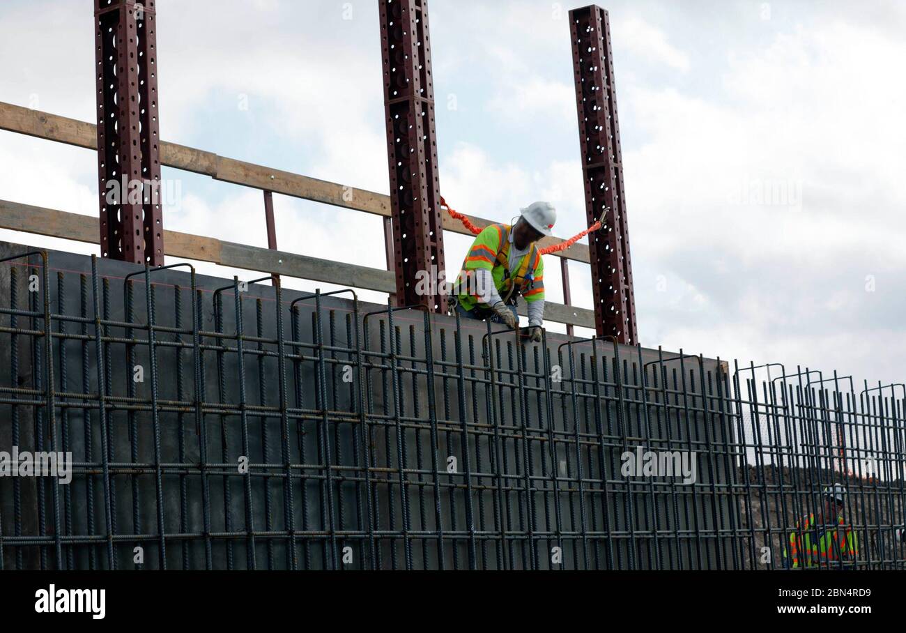 Construction workers begin erecting steel forms for the foundation of ...