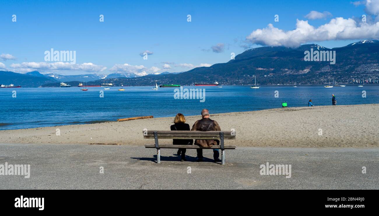 People sitting on bench along English Bay, Vancouver, Lower Mainland ...