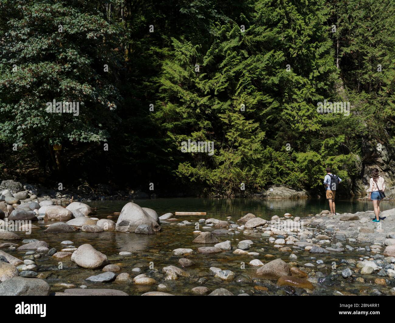 Couple standing on rocks, Lynn Canyon Park, Vancouver, Lower Mainland ...