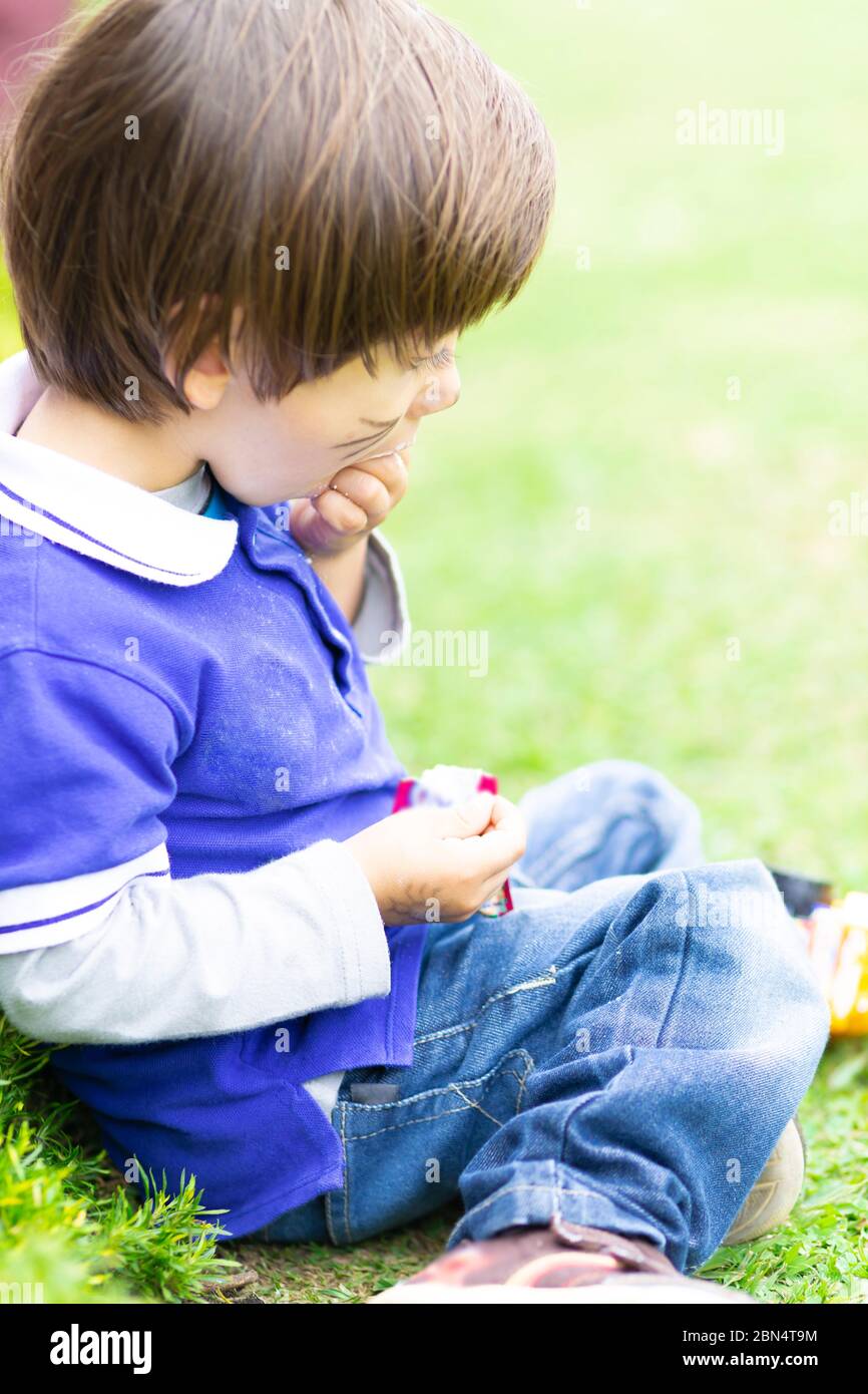Happy Child Eating Delicious Food Outdoors Stock Photo - Alamy