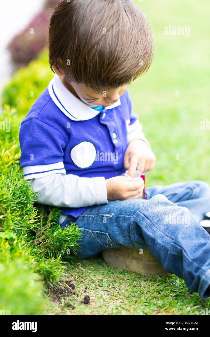 Happy Child Eating Delicious Food Outdoors Stock Photo - Alamy