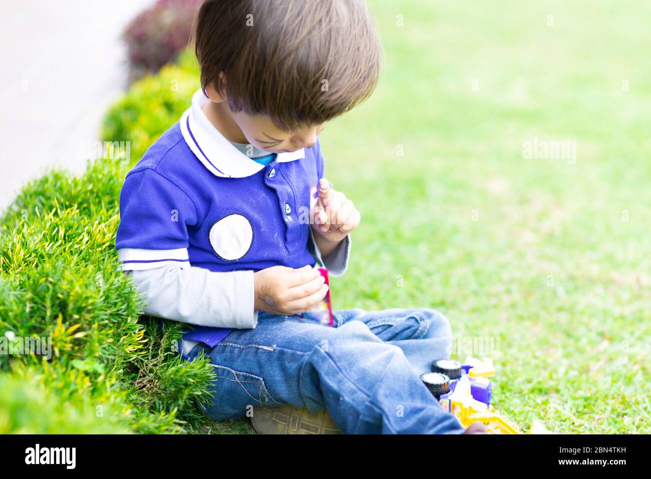 Happy Child Eating Delicious Food Outdoors Stock Photo - Alamy