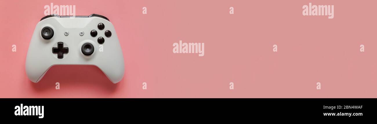 White joystick gamepad, game console isolated on pastel pink colourful ...