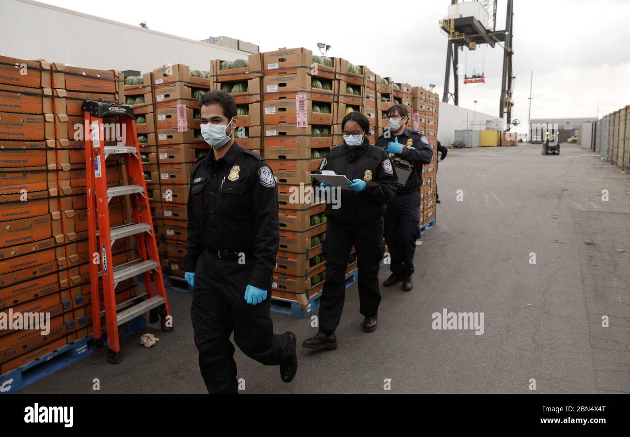 Wearing personal protective equipment (PPE) U.S. Customs and Border ...