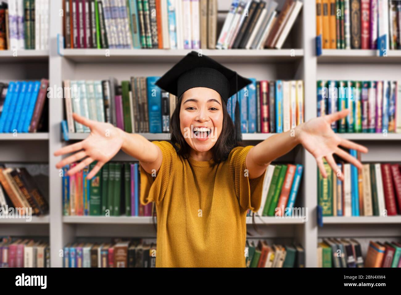 Graduate girl in front of a library. Concept of preparation and ...