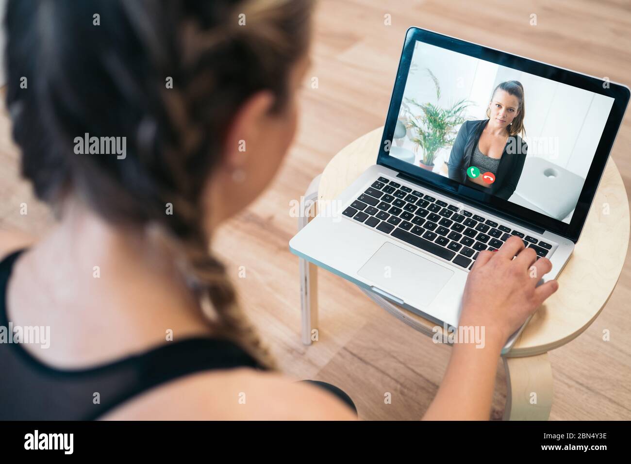 Back view of female employee speak talk on video call with a colleague ...