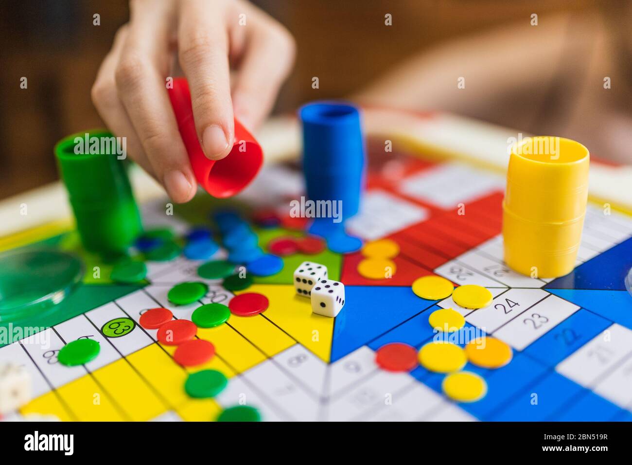 Woman Hand throwing two dices playing Parcheesi, Parchis game over game ...