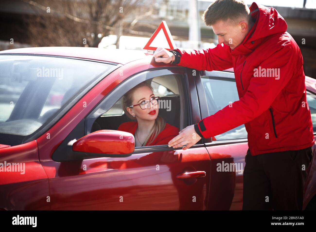 Driving instructor and woman student in examination car Stock Photo - Alamy