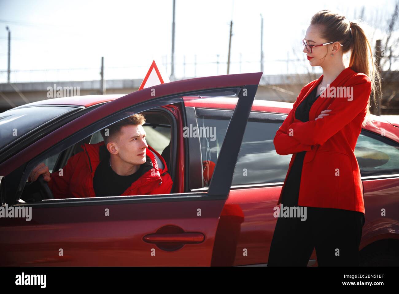 Driving instructor and woman student in examination car Stock Photo - Alamy