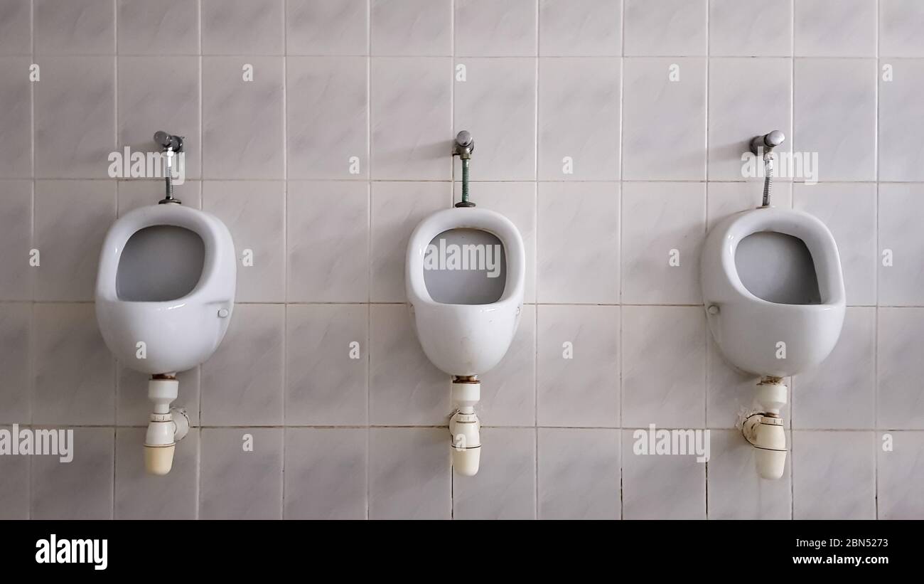 Public toilets with lots of ceramic urinals. Large public toilet, wall ...