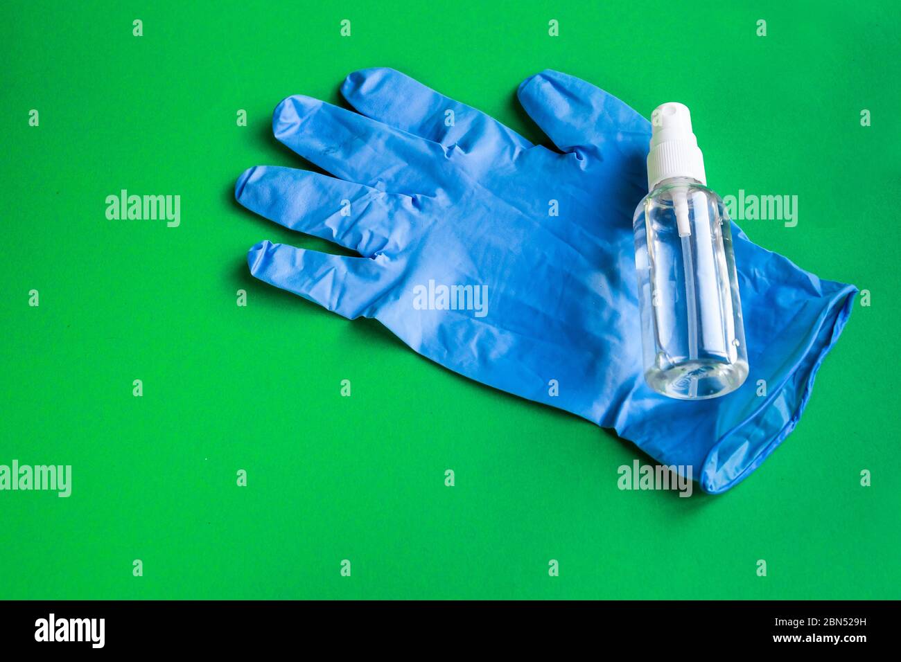 Hand picked sanitizer and blue medical glove as protection against ...