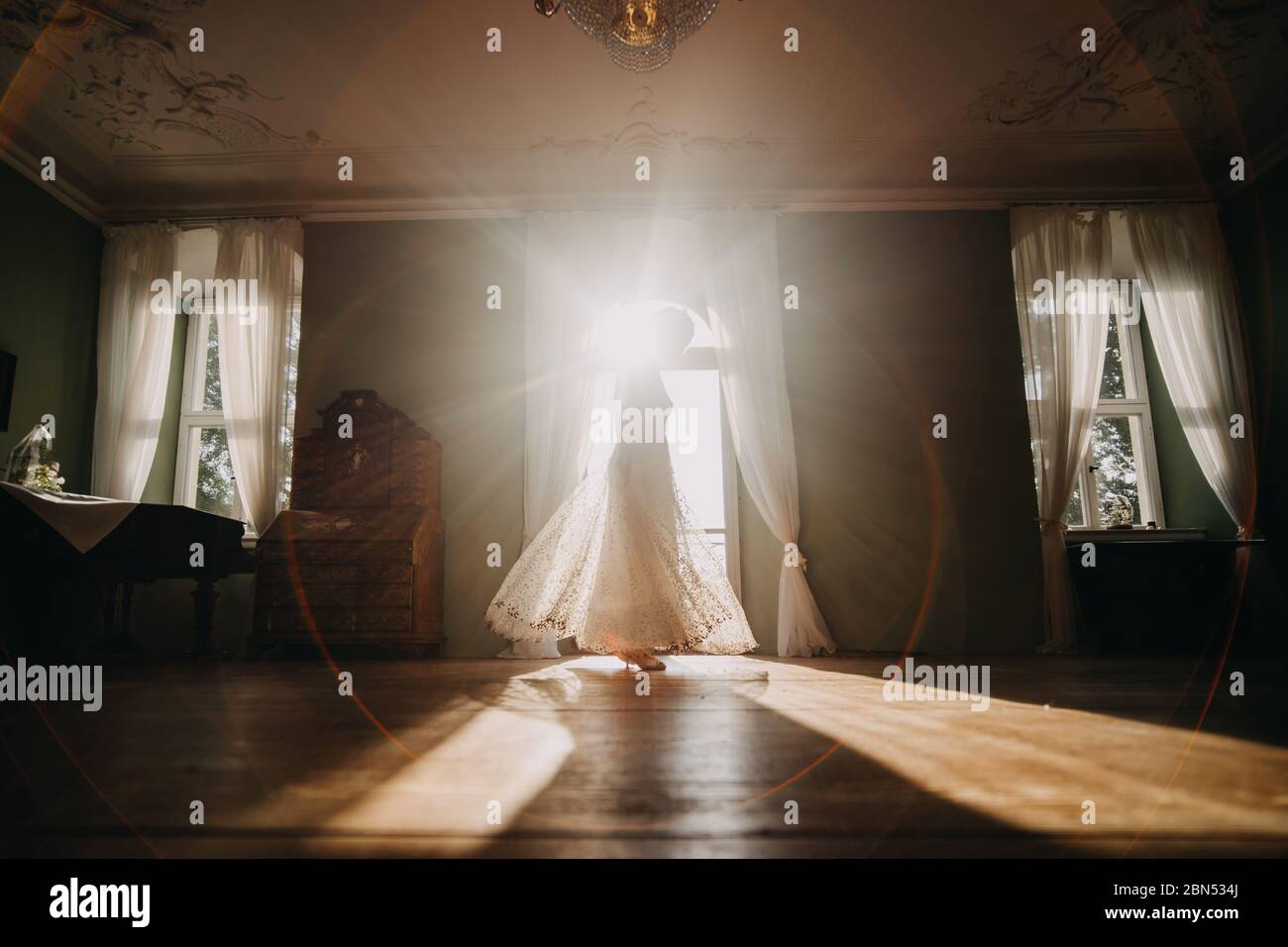 photo of a bride dancing in the light at the window Stock Photo - Alamy