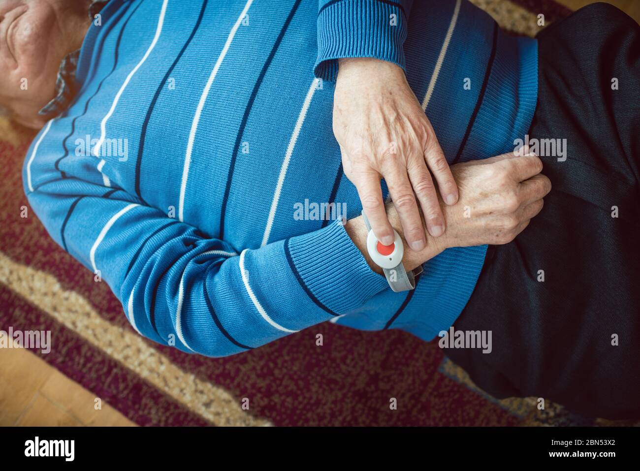 Senior man fallen pressing red button on emergency call device Stock ...