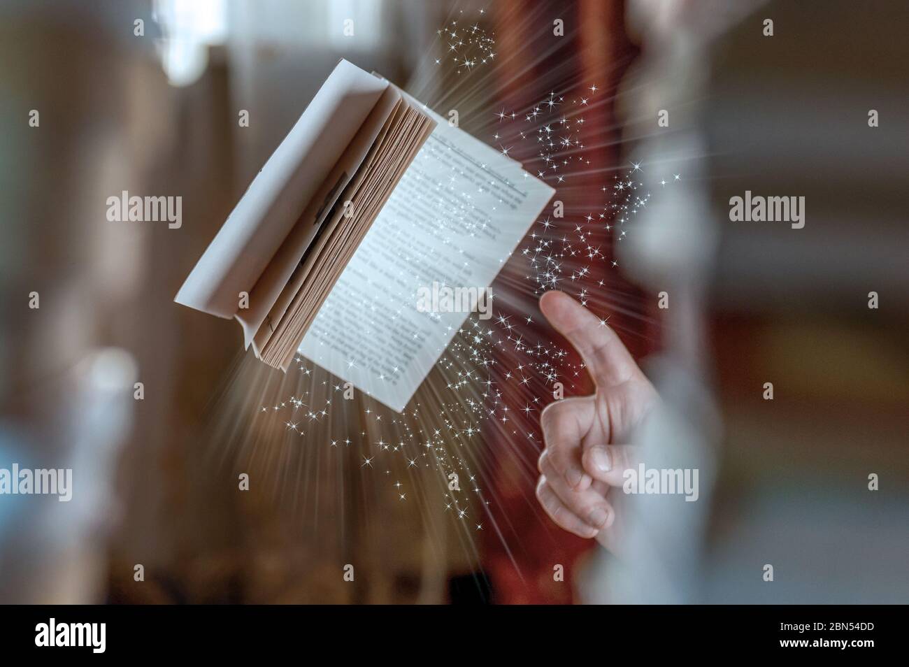 Magic book and male hand. Male magician with spell book Stock Photo - Alamy