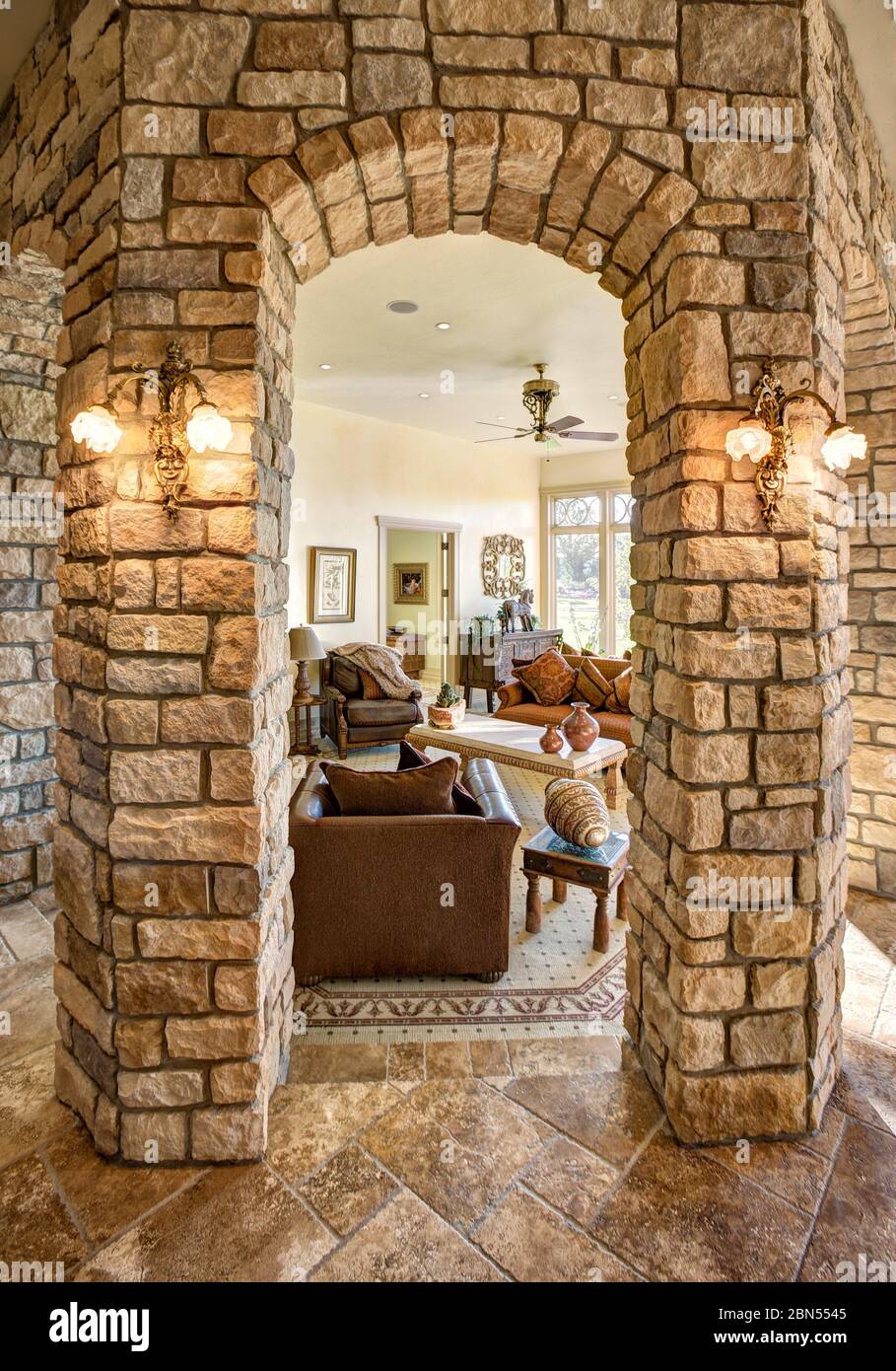 Elegant home interior with stone arch Stock Photo - Alamy