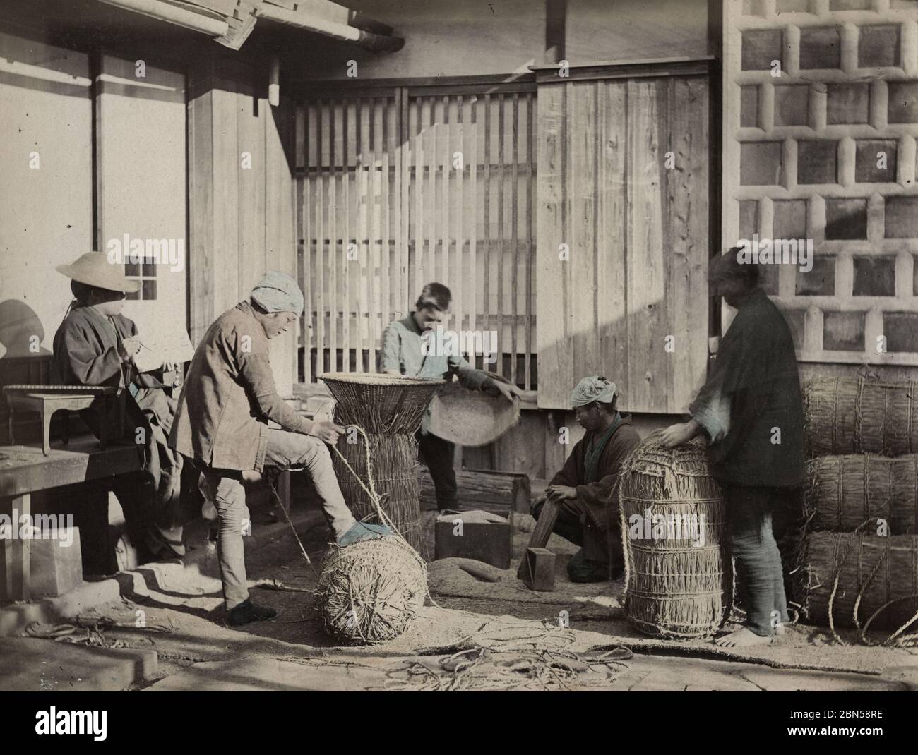 Farm workers packing bales of rice, Japan Stock Photo - Alamy