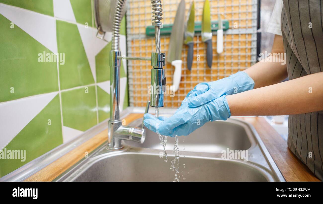 Woman in blue protective gloves washing hands with soap Stock Photo - Alamy