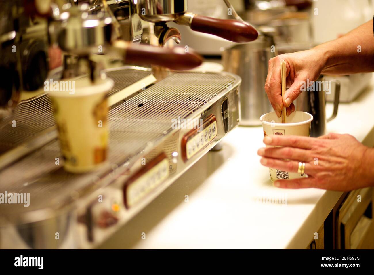 Take out coffee cup on the shelf of a coffee machine as the shot of ...