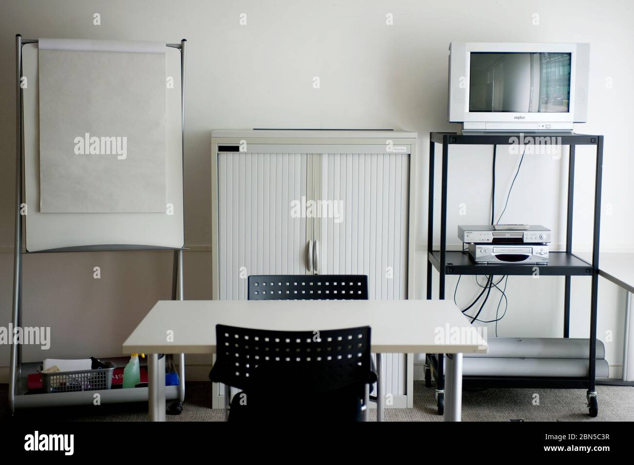 Office layout with monitor, desk, cupboard, wipe board, and flip paper ...