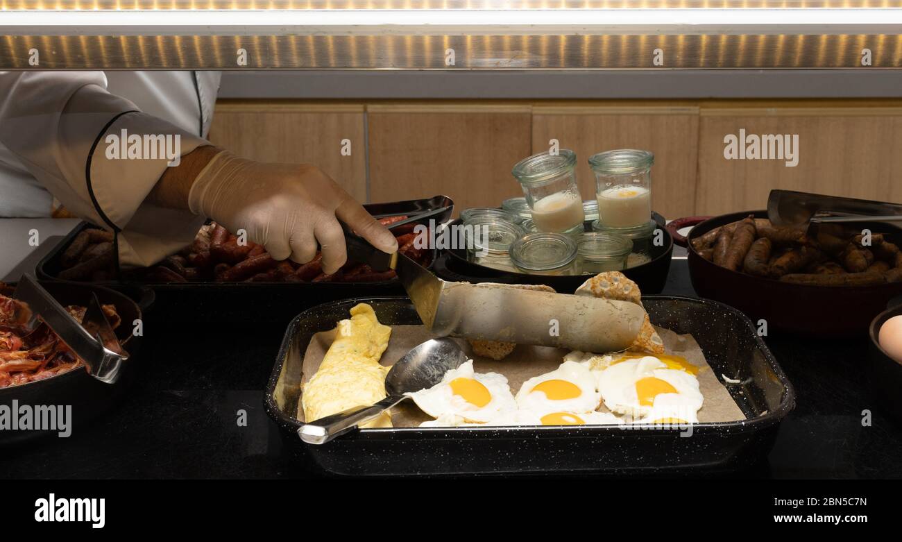 Fried and scrambled eggs and omelette station in a hotel or restaurant ...