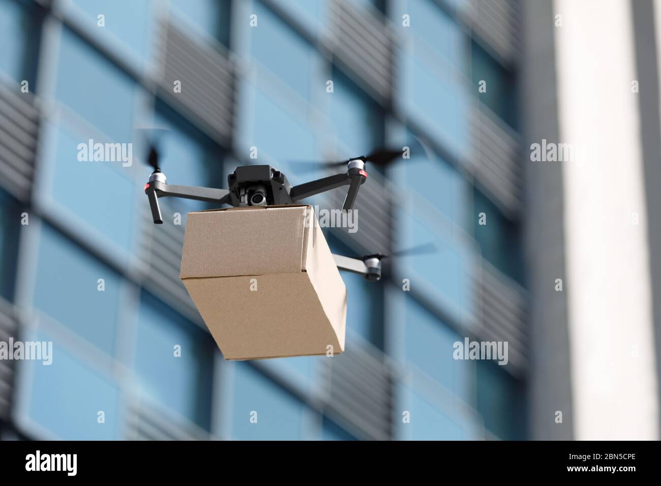 Drone flying through the air with a delivery box package Stock Photo ...