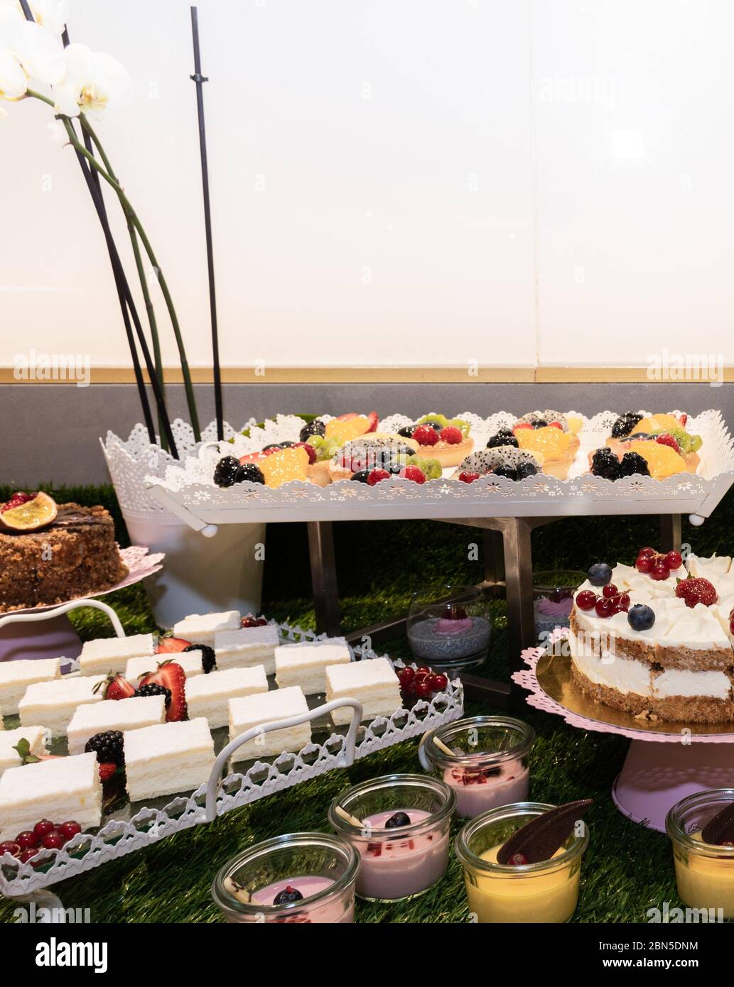 Large assortment of desserts, muffins, cakes, tarts. Candy bar during ...