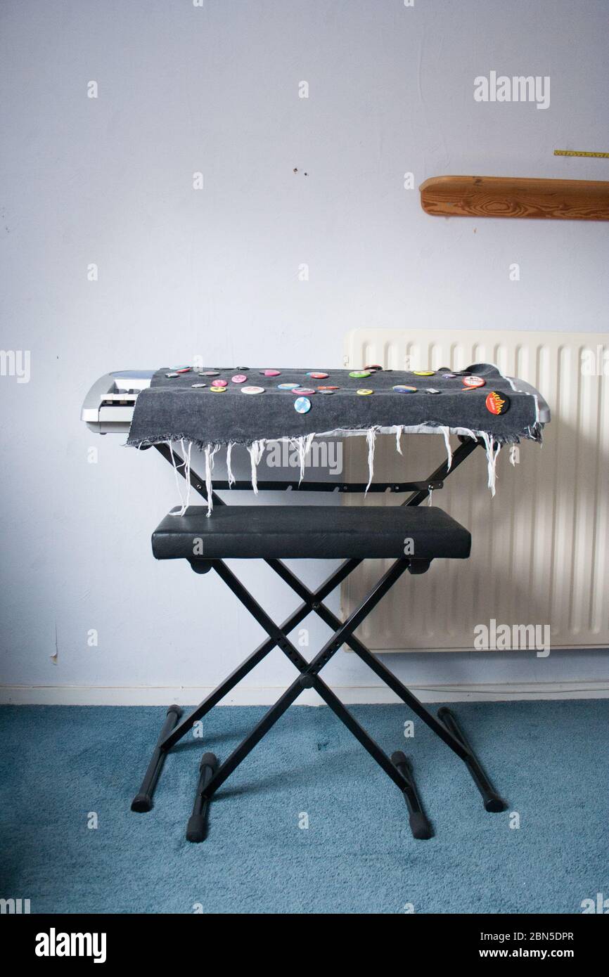 Keyboard with stool in a room Stock Photo - Alamy