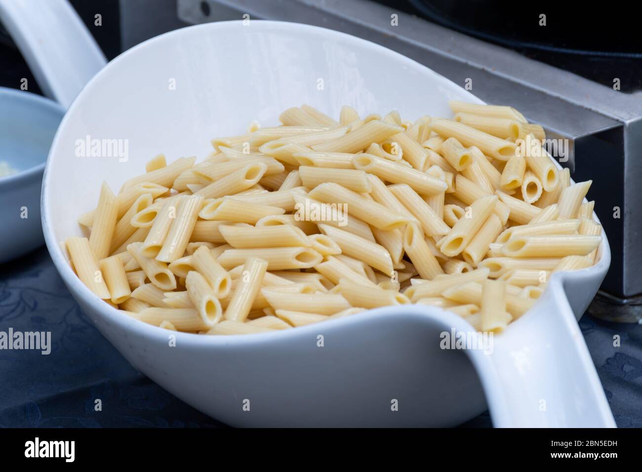 Chef preparing pasta boiling pasta and cooking. Food catering live ...