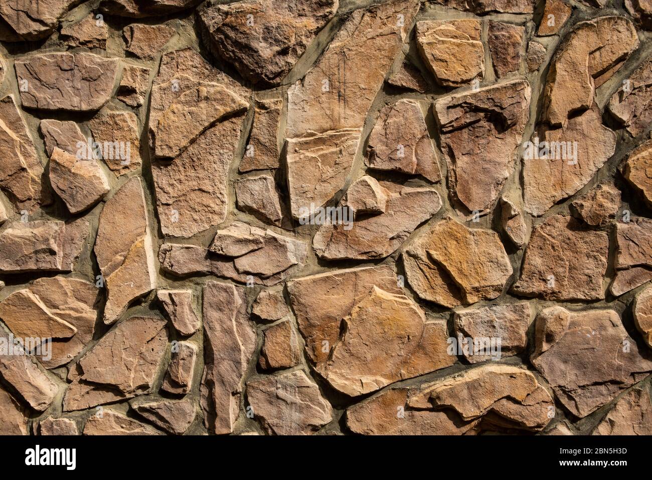 Brown stone wall texture background Stock Photo - Alamy
