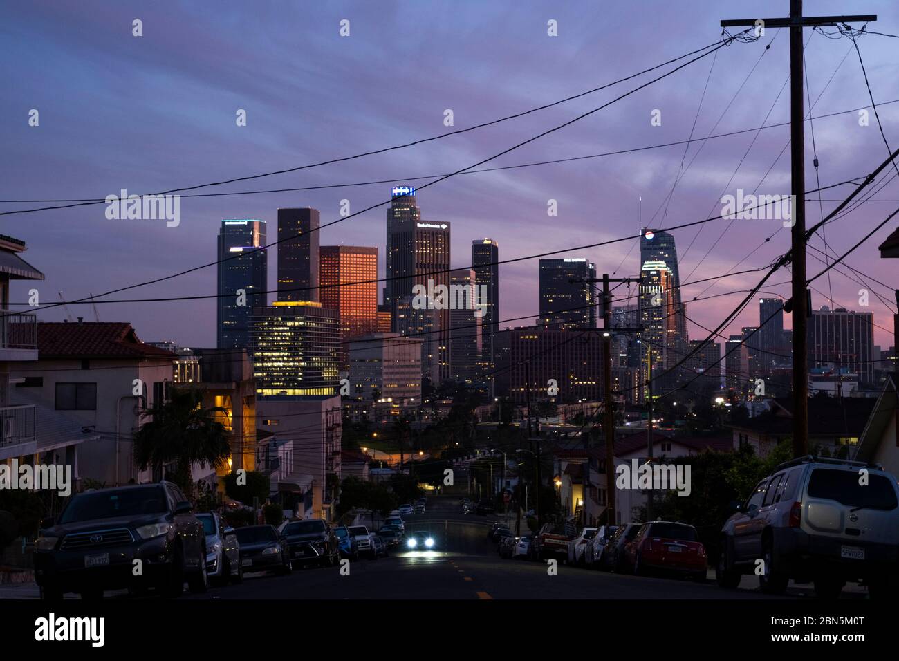 Gritty sunset view of downtown Los Angeles with power lines Stock Photo ...