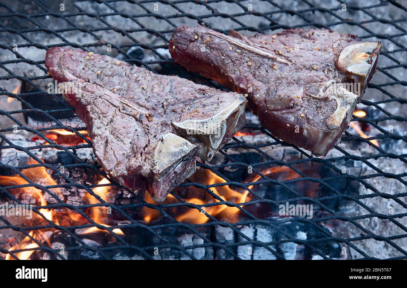 Grilling beef steaks on flaming grill. View from above Stock Photo - Alamy