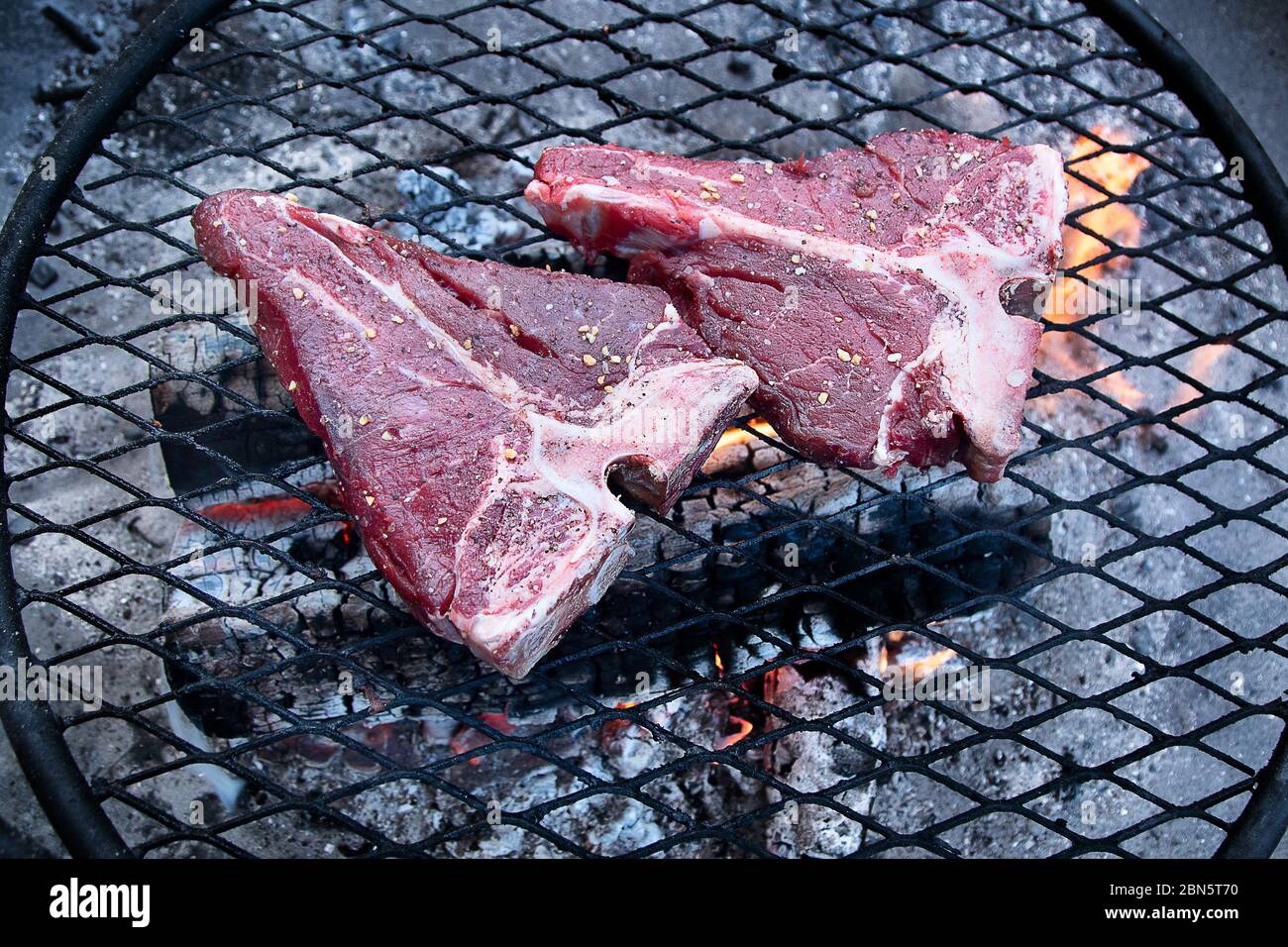 Grilling beef steaks on flaming grill. View from above Stock Photo - Alamy
