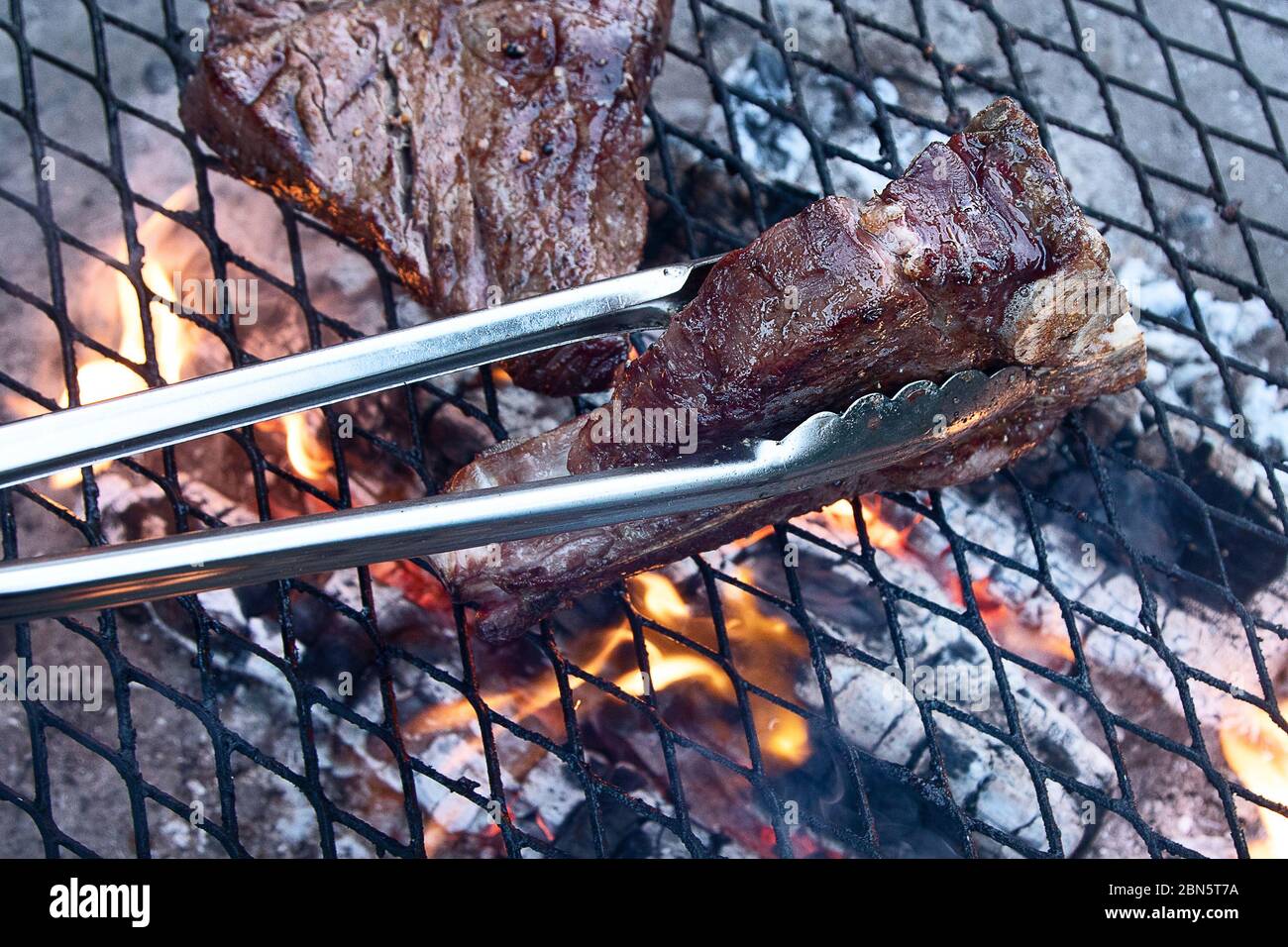 Grilling beef steaks on flaming grill. View from above Stock Photo - Alamy
