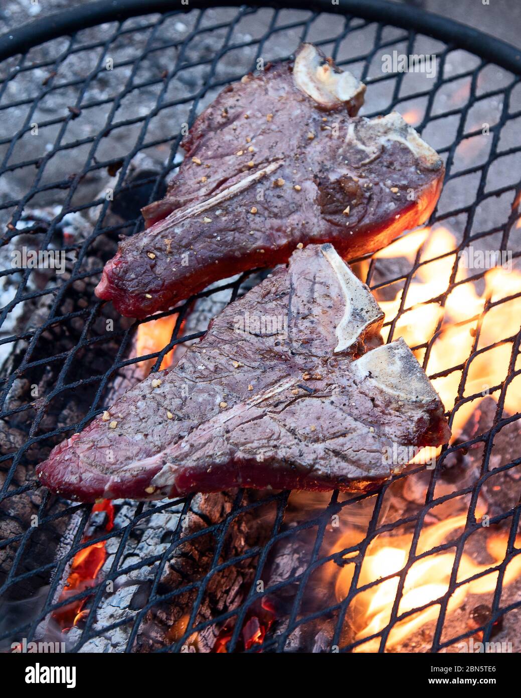 Grilling beef steaks on flaming grill. View from above Stock Photo - Alamy