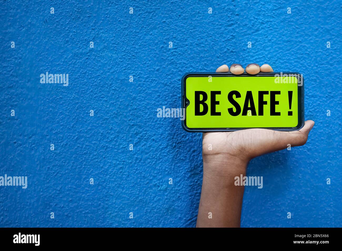 Be Safe world on smart phone screen isolated on blue background with ...