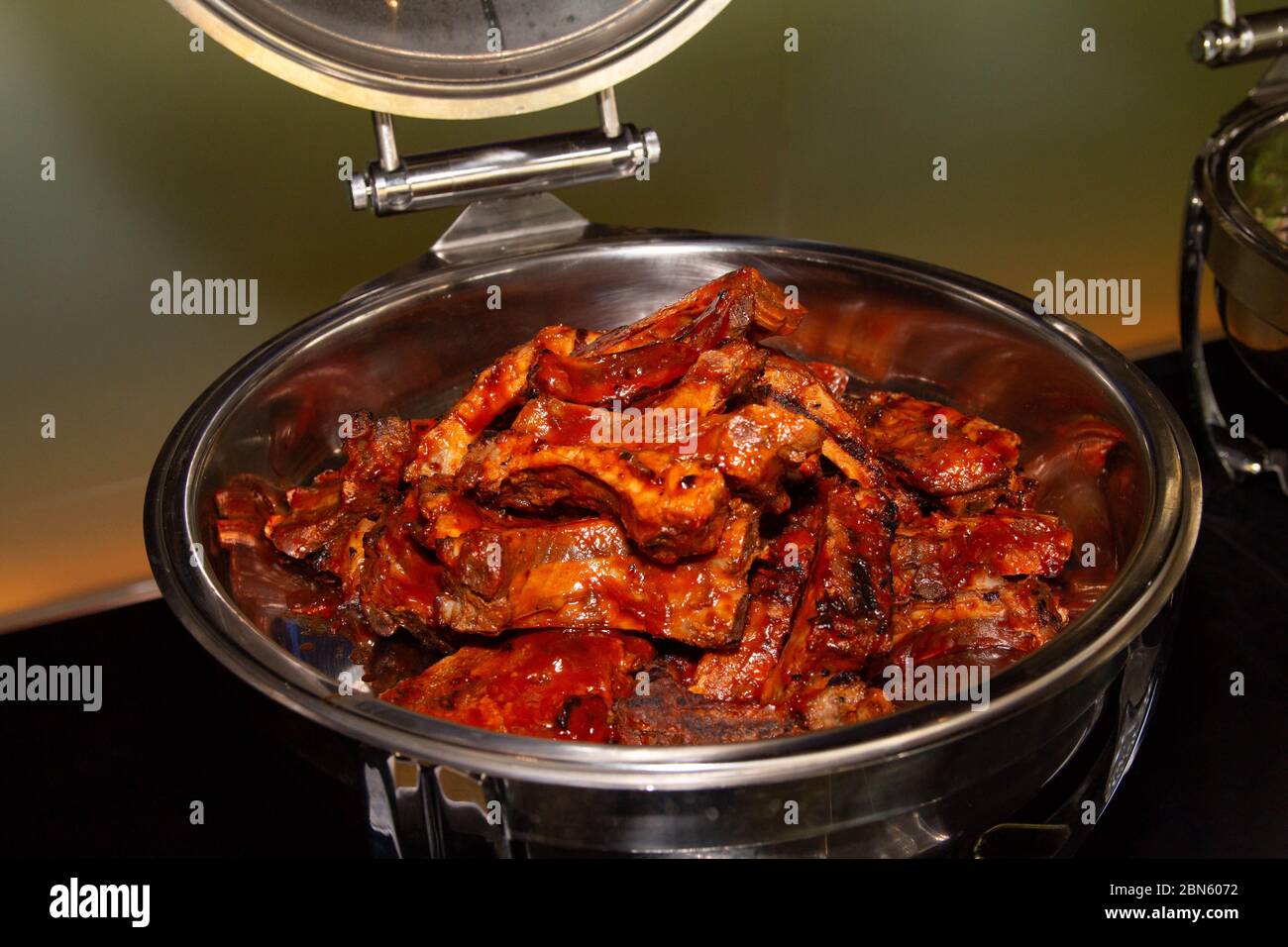 Large portion of pork ribs inside a restaurant buffet tray Stock Photo ...