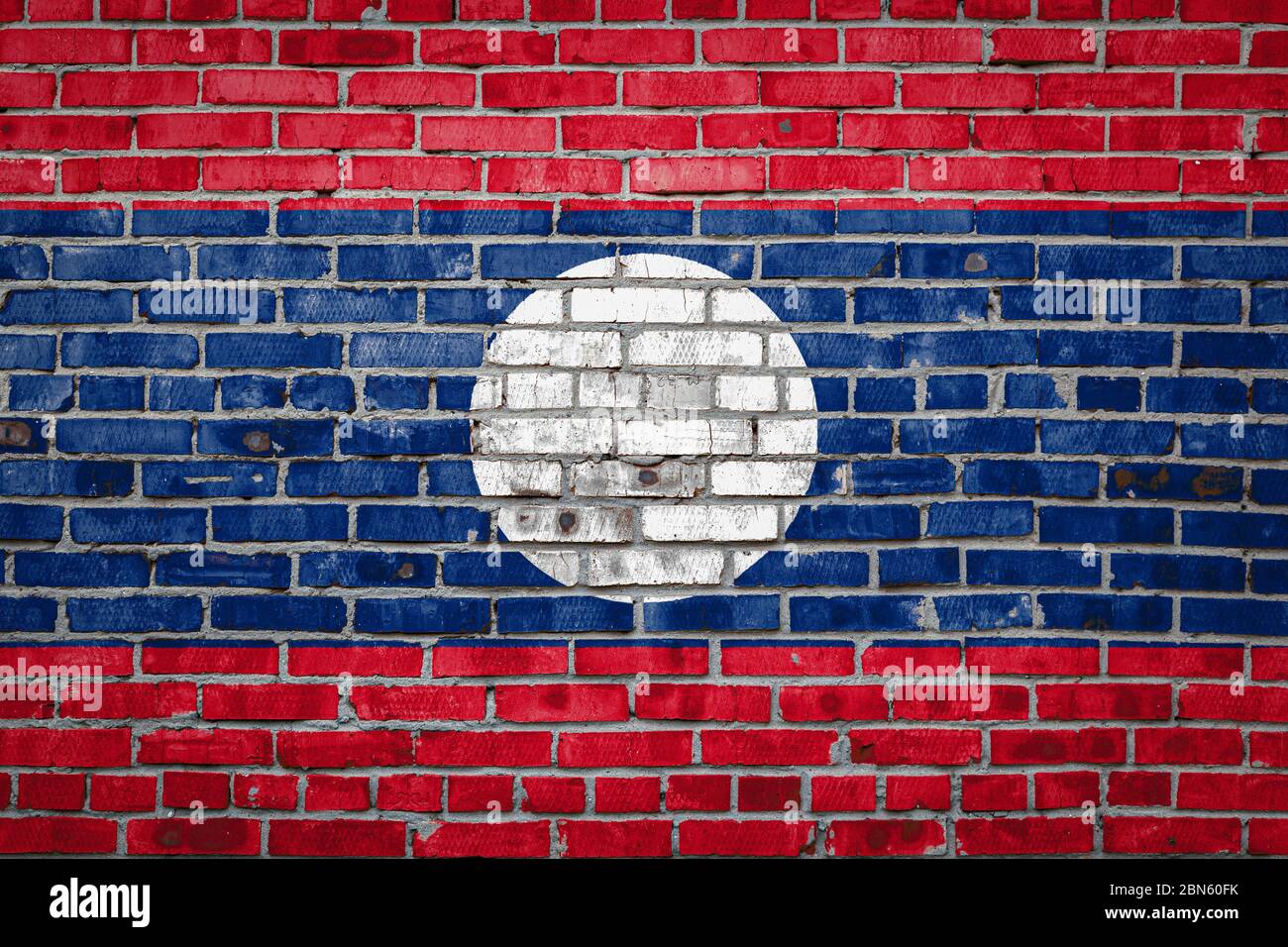 National flag of Laos depicting in paint colors on an old brick wall ...