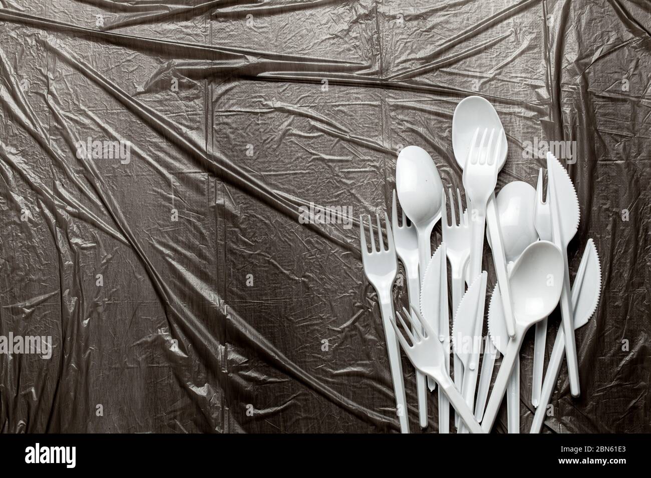 Plastic cutlery, forks, spoons and knives. Pollution of the environment ...