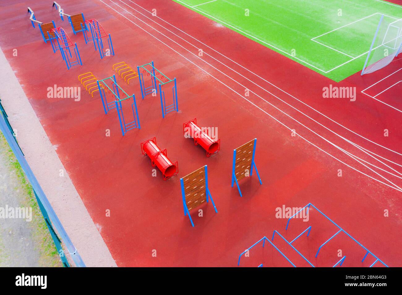 Playground with obstacle course on a sports court next to treadmills ...